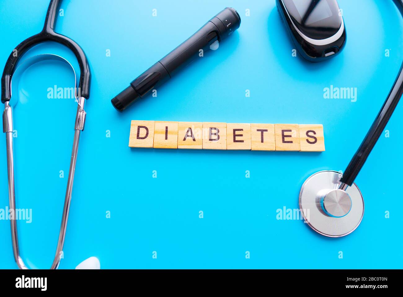 Diabetes Text. Stethoscope and blood glucose meter, lancet on the blue ...