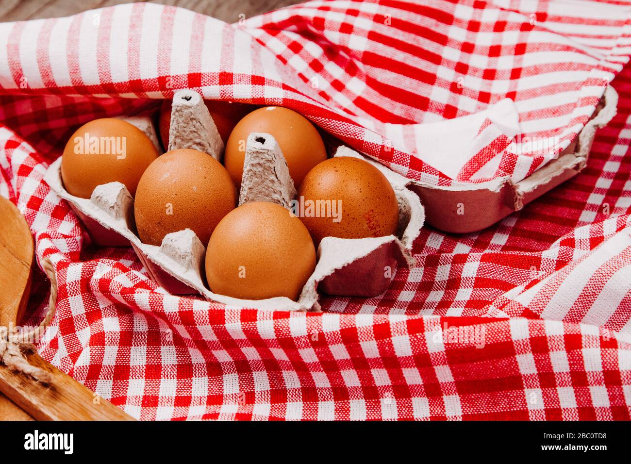 Wooden ladles, garlic and eggs on a red and white table rug Stock Photo ...
