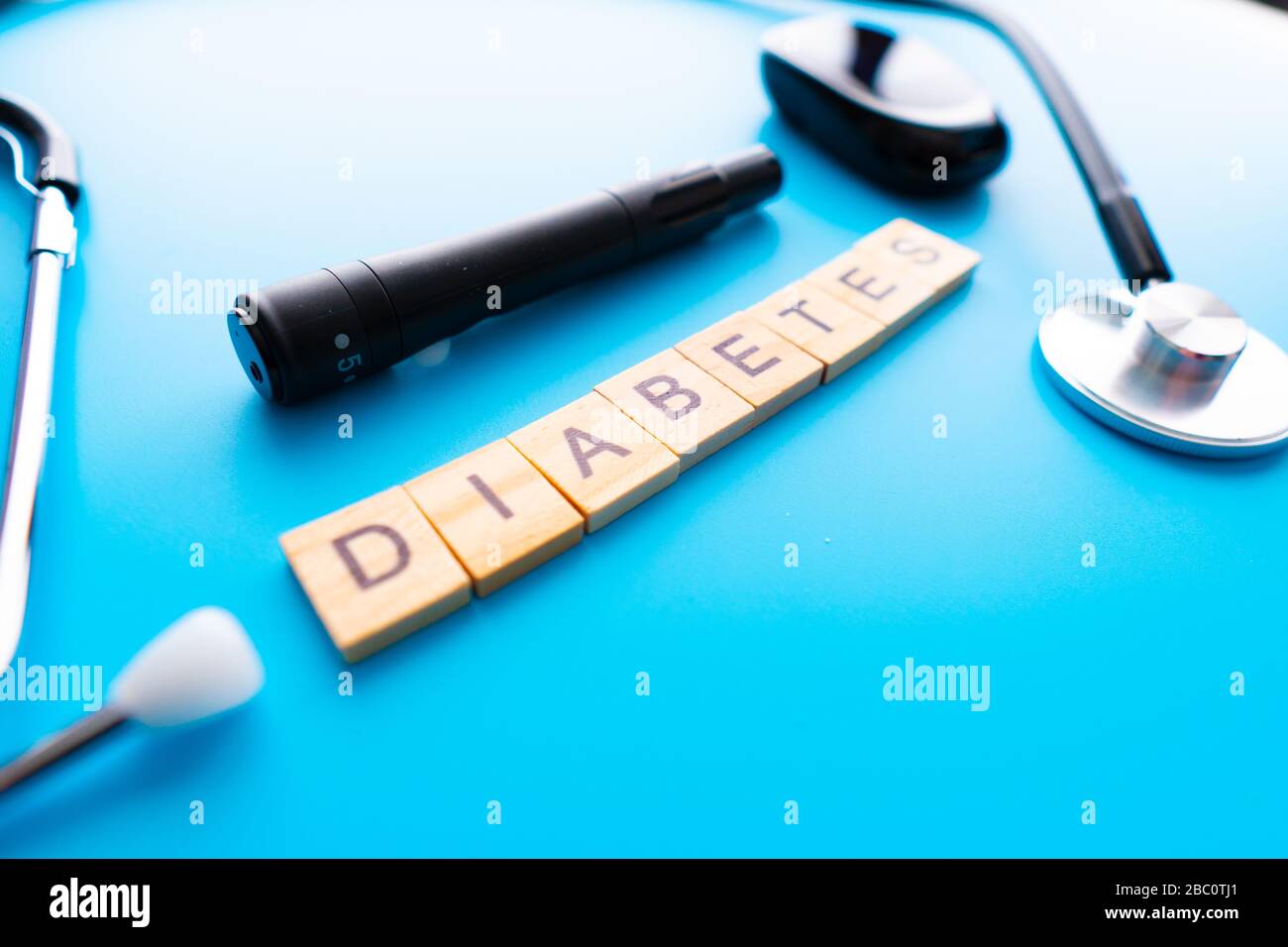 Wooden text Diabetes. Diabetes concept. Syringe, Glucometer or Glucose ...