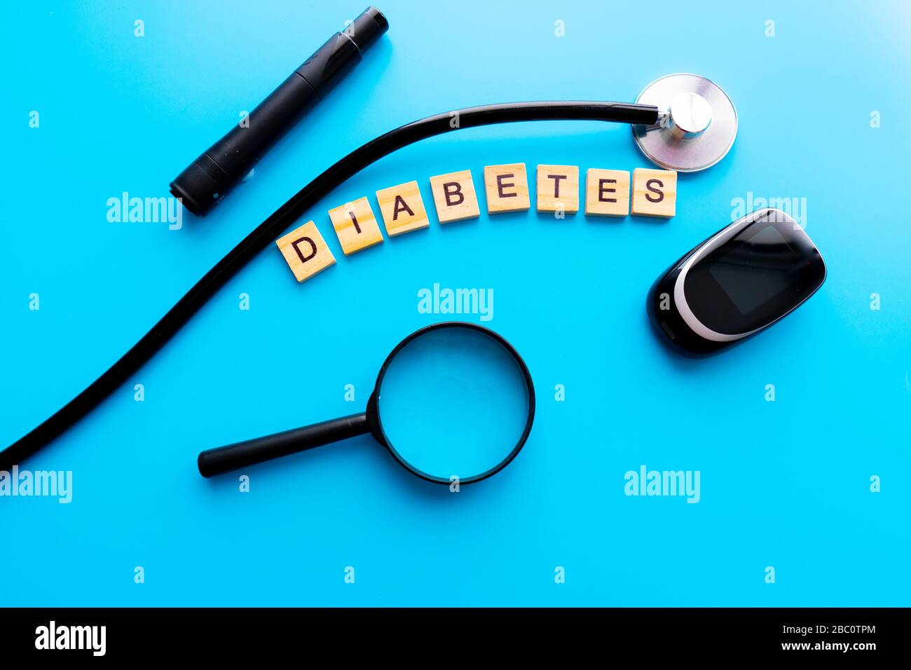Wooden text Diabetes. Diabetes concept. Syringe, Glucometer or Glucose ...