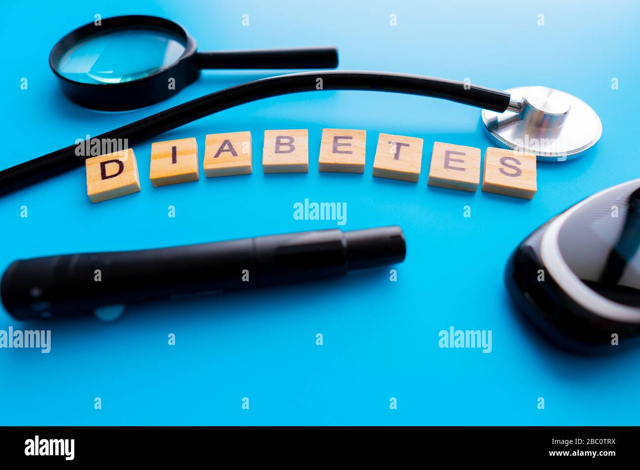 Wooden text Diabetes. Diabetes concept. Syringe, Glucometer or Glucose ...
