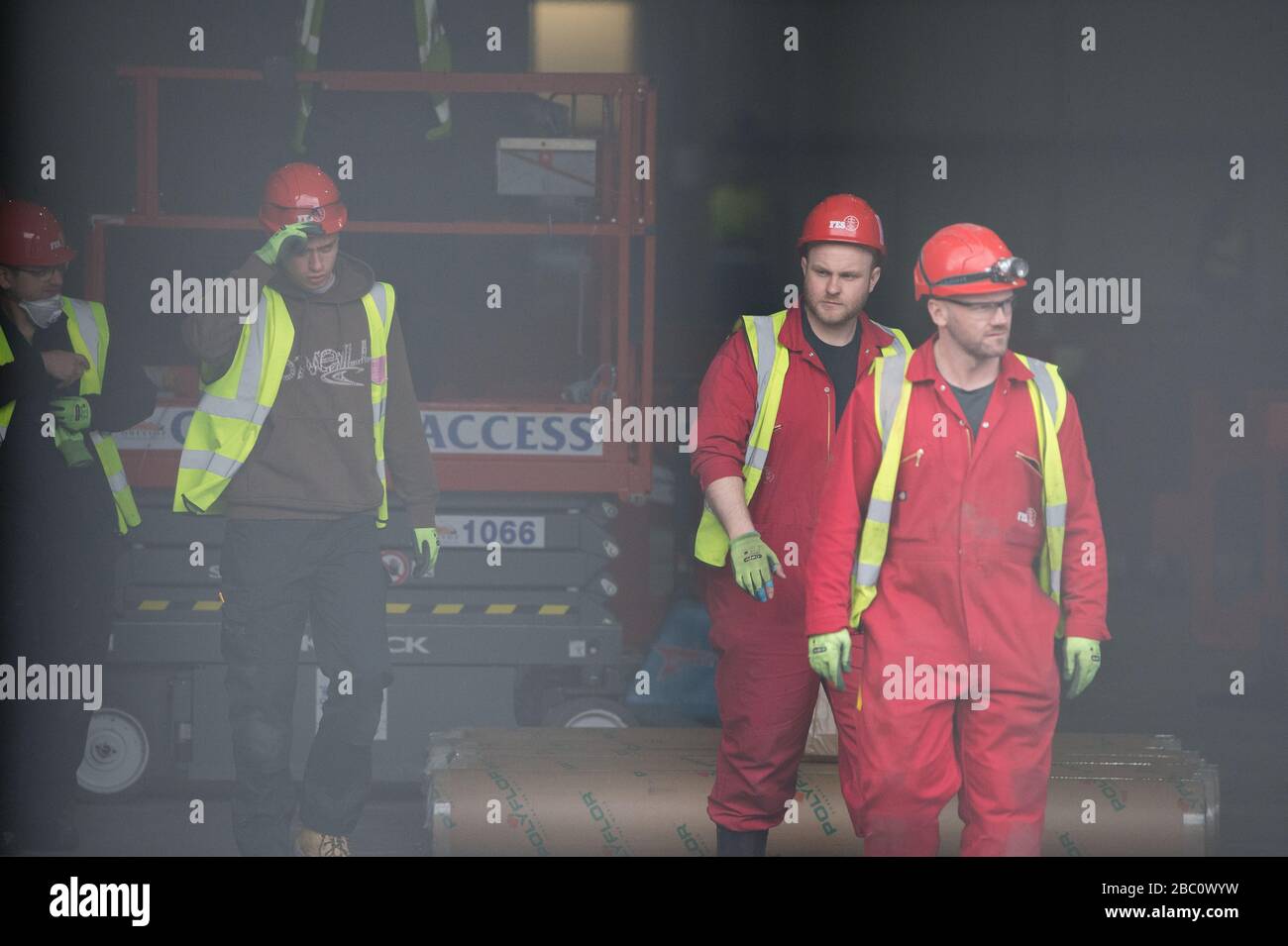 Construction workers wearing red boiler suits hi-res stock photography ...