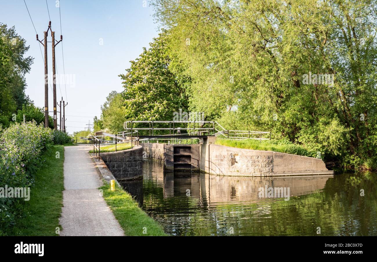 English canal lock and tow path, Hertfordshire, England. A spring rural ...