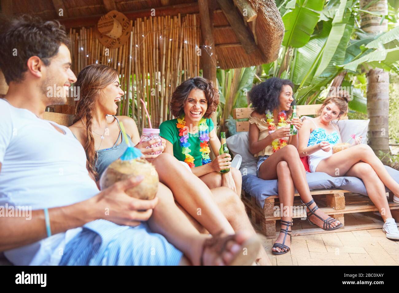 Young friends hanging out drinking and talking at summer poolside Stock ...