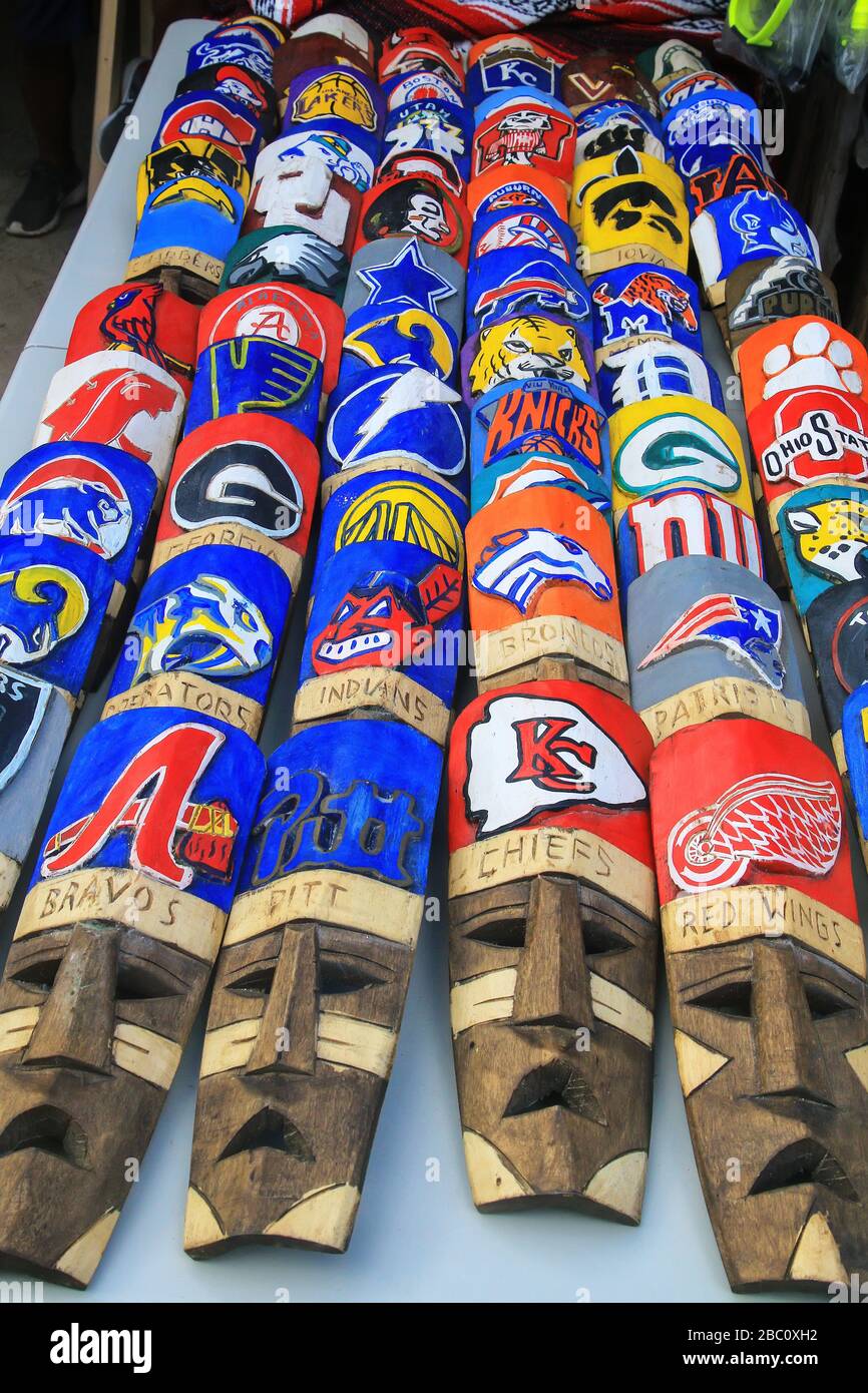 Display of sport teams masks at a street market in Mahahual village ...