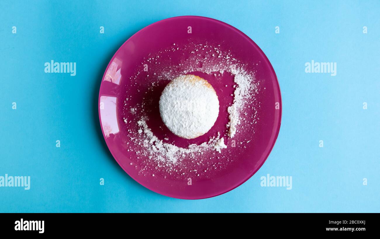 Sprinkle one cottage cheese with powdered sugar on a pink plate, on a ...