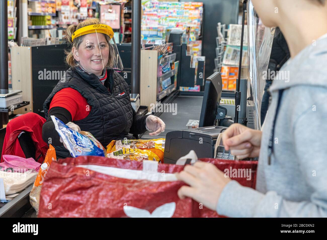 CASHIER AT AN INTERMARCHE SUPERMARKET WEARING A PROTECTIVE FACE MASK ...