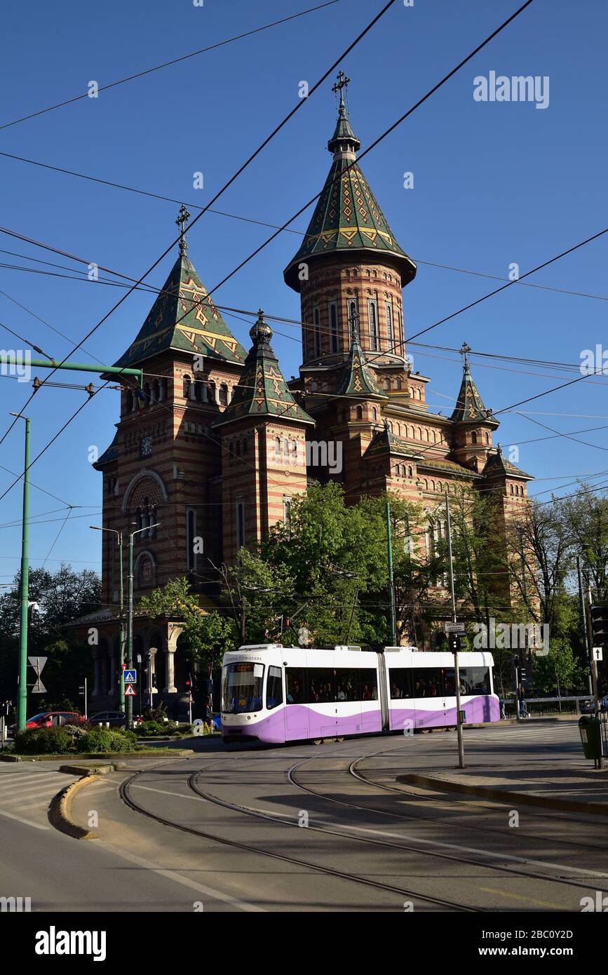 Romania, Timis, Timisoara, Modern tram passing Metropolitan Orthodox ...