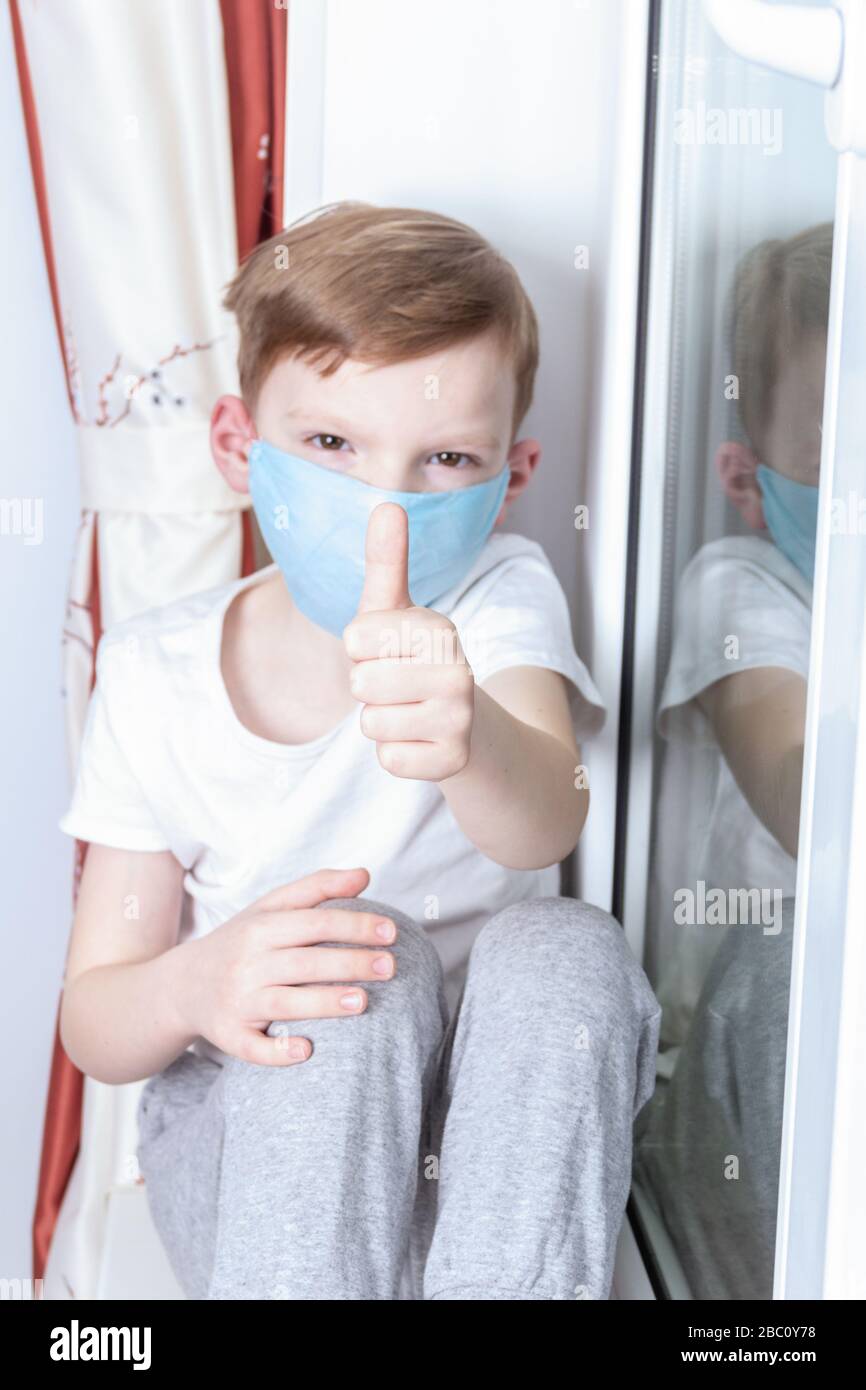 Self-isolation and quarantine concept. A seven-year-old boy in a ...