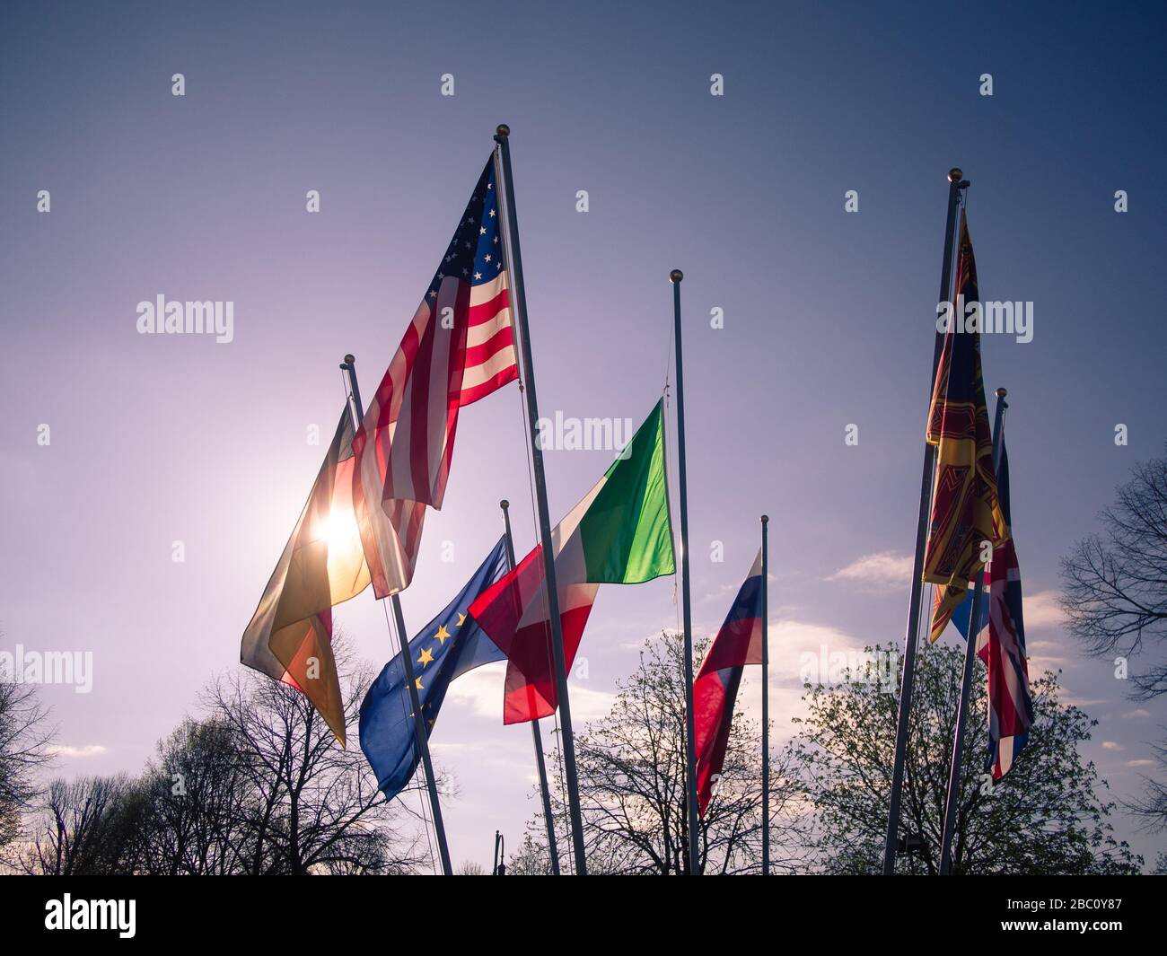 Flags of various states of the world fly together at sunset Stock Photo ...