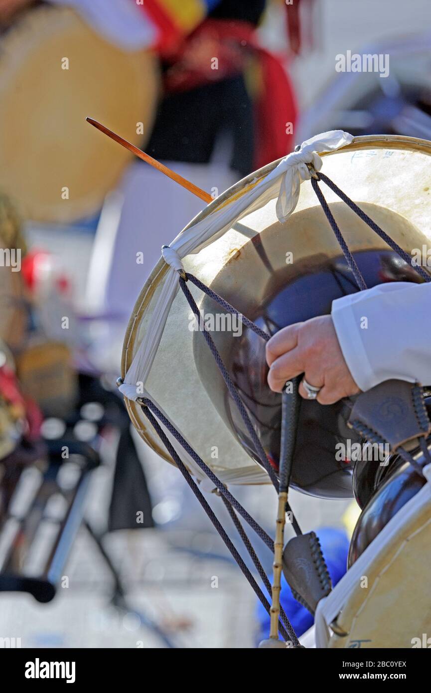 South Korean drummer playing a janggu (or janggo; also spelled changgo ...