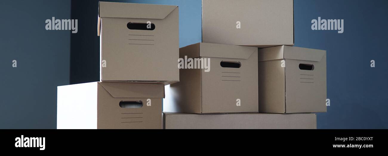 Pile of carton boxes standing in the middle of empty room in new house ...