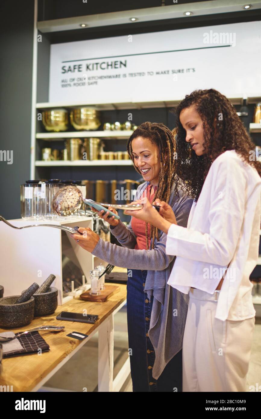 Women with smart phone shopping in home goods store Stock Photo - Alamy
