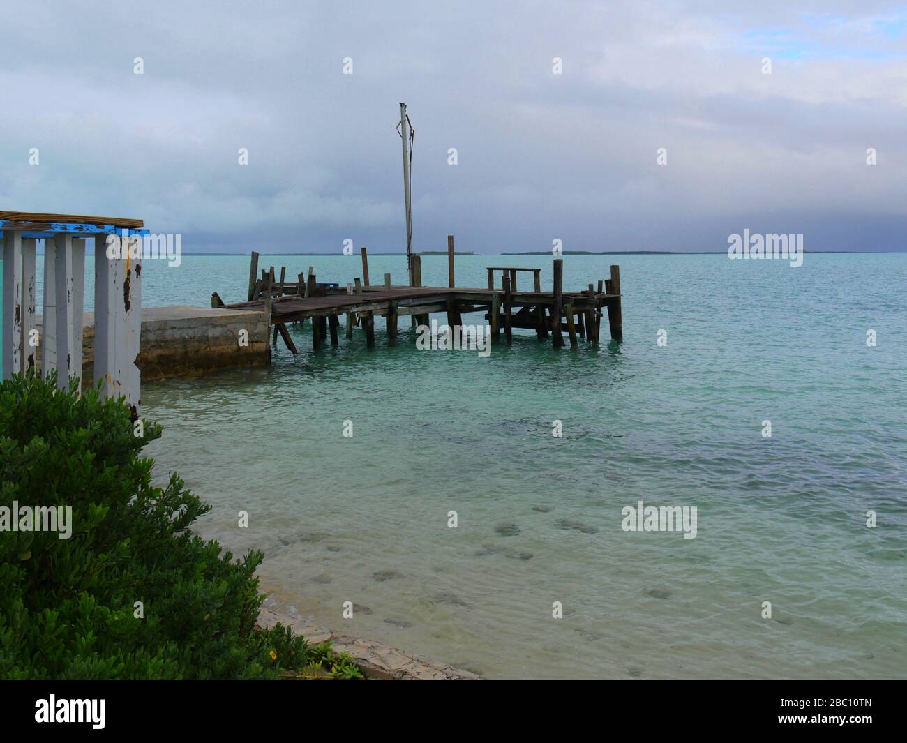 Rickety old wooden dock for boats in a shallow area of Barraterre dock ...