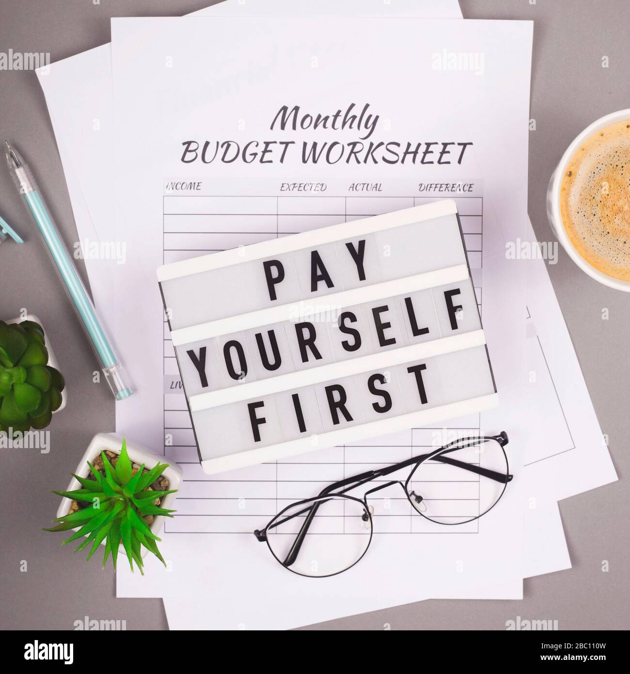 Pay yourself first. It is written on a decorative panel on the gray ...