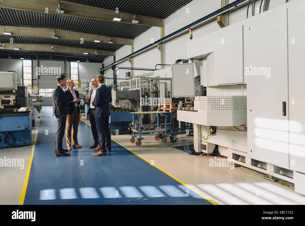 Business team having a meeting in a factory Stock Photo - Alamy
