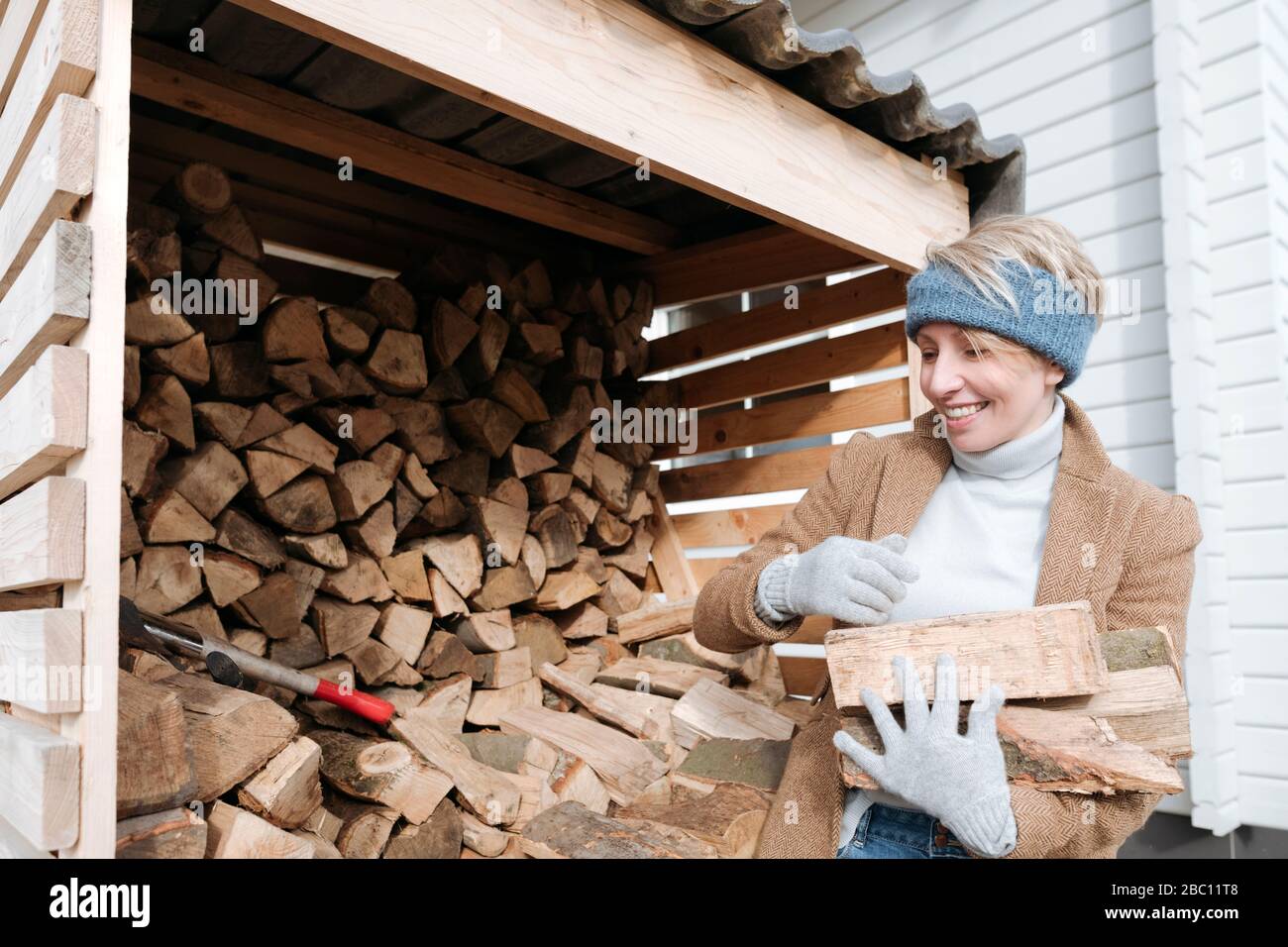 Person stack firewood holding hi-res stock photography and images - Alamy