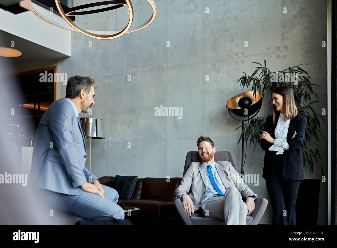 Business people having a meeting in hotel lobby Stock Photo - Alamy
