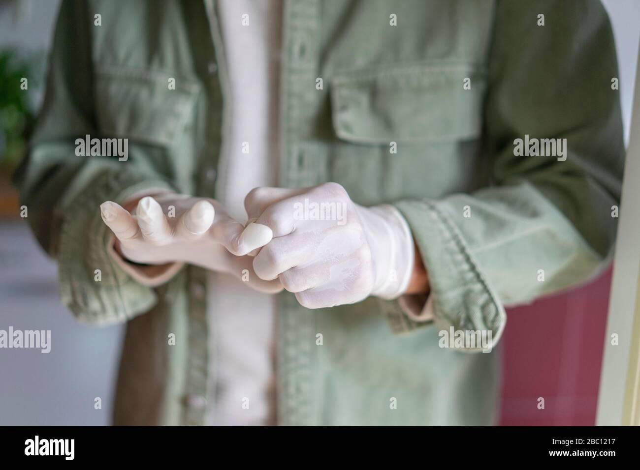 Man putting on protective gloves Stock Photo - Alamy