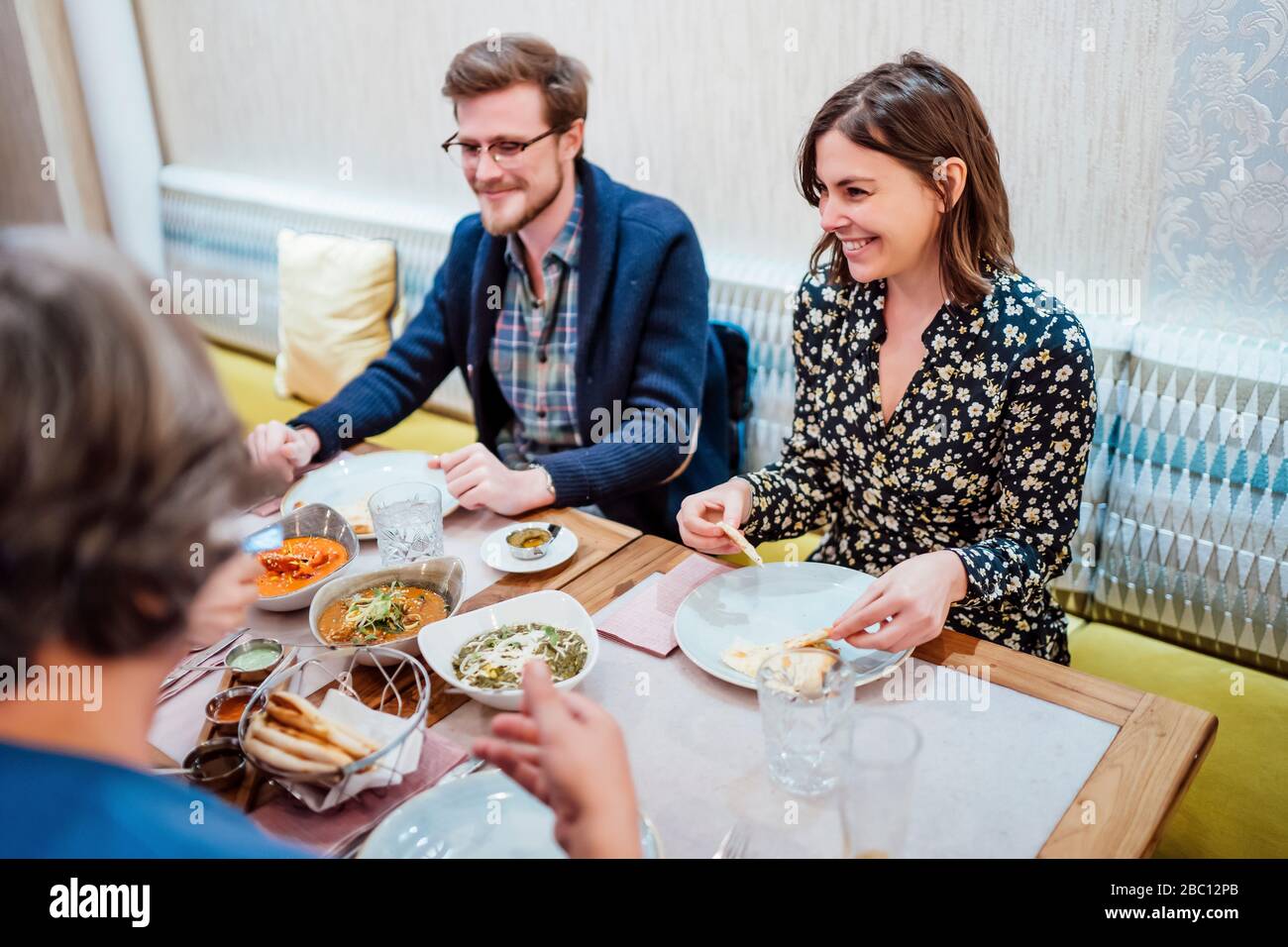 Friends dining in an Indian restaurant Stock Photo - Alamy