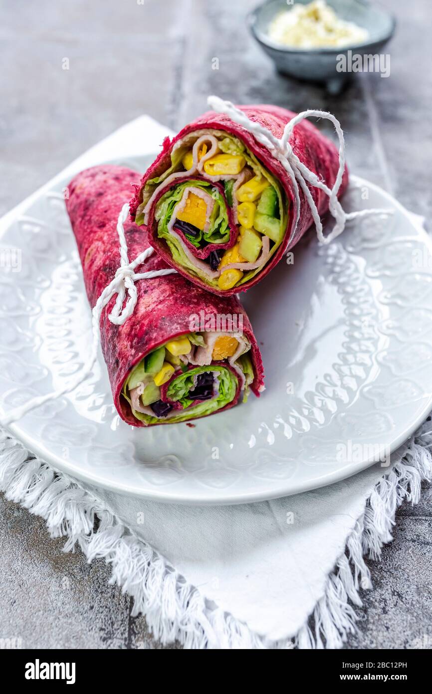 Beetroot wraps filled with ham, cheese, corn, iceberg lettuce ...