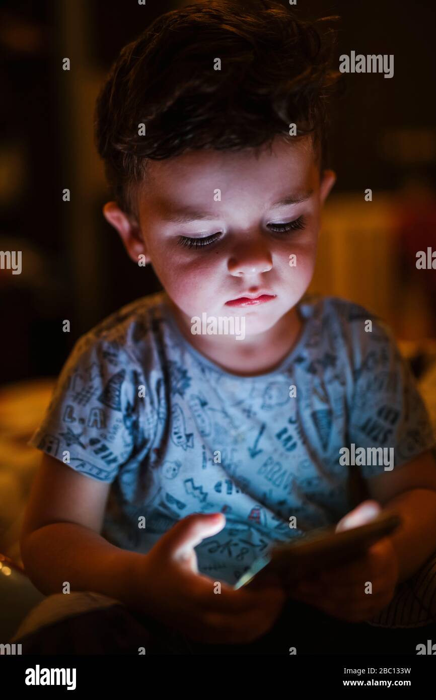 Portrait of toddler looking at smartphone Stock Photo - Alamy