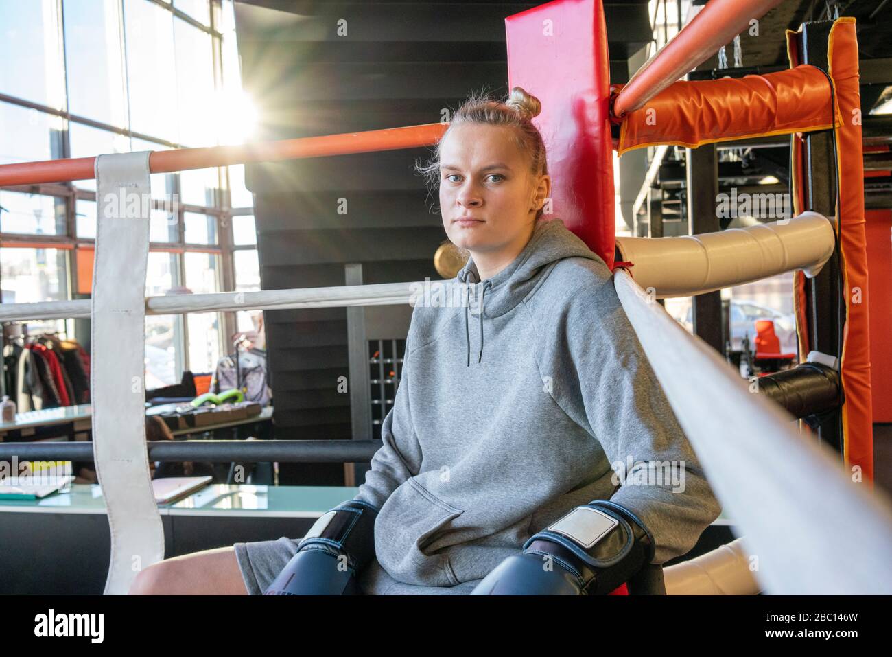 Portrait of a female boxer in gym sitting in ring corner Stock Photo ...