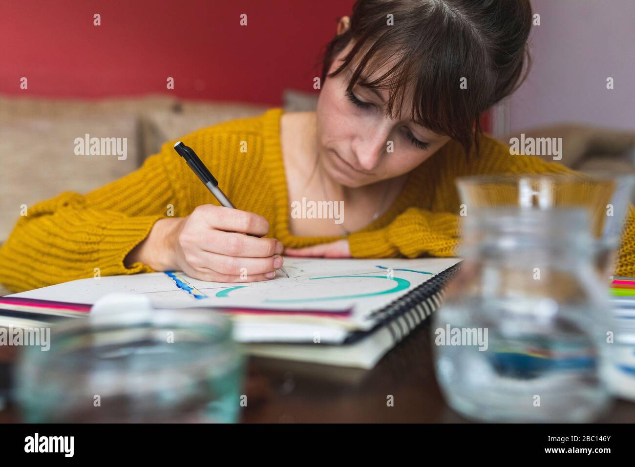 Portrait of woman drawing at home Stock Photo - Alamy