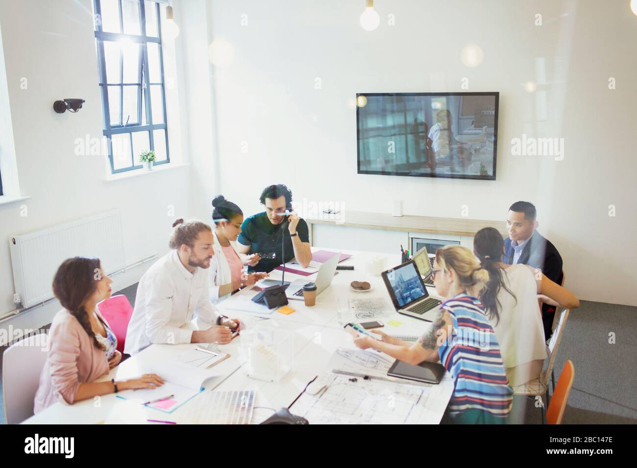 Architects working in conference room meeting Stock Photo - Alamy