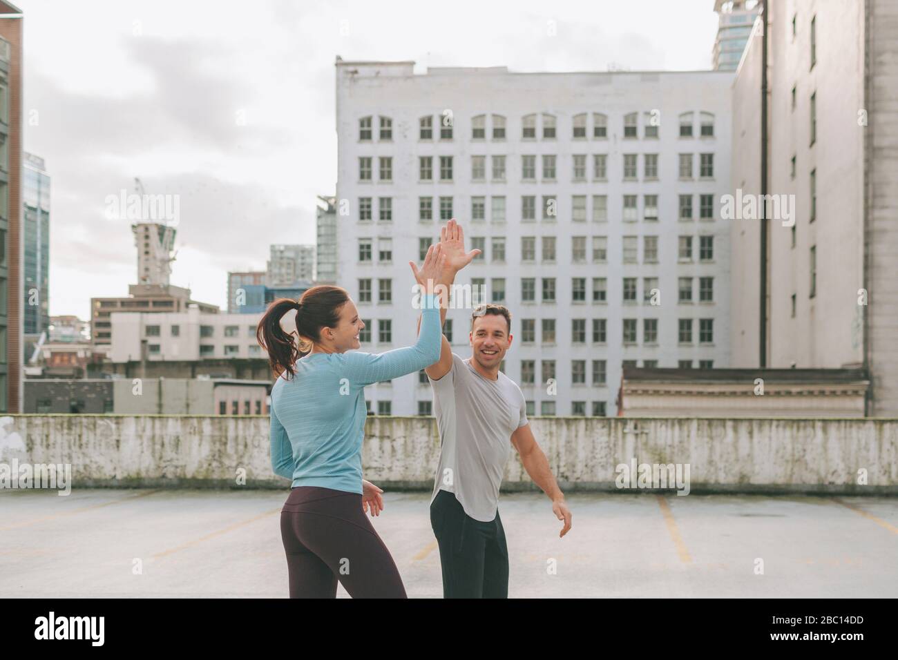 Man and woman high five during a workout in the city, Vancouver, Canada ...