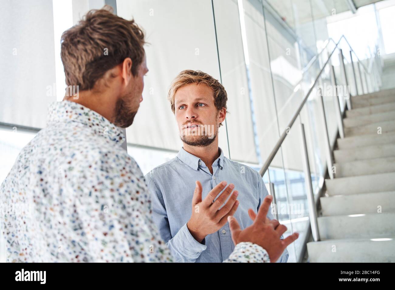 Two friends talking listening indoors hi-res stock photography and ...