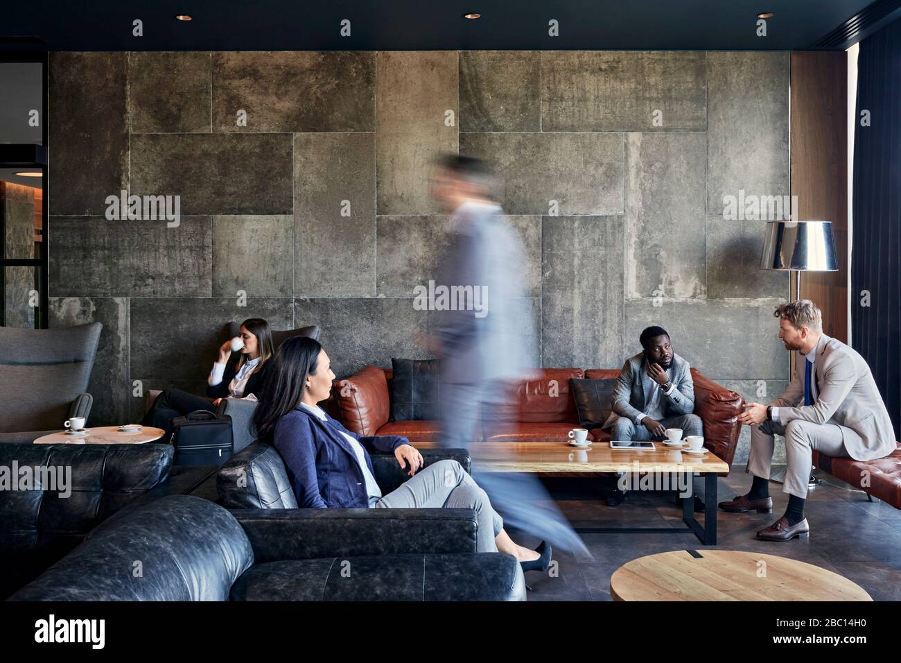 Business people having a meeting in hotel lobby Stock Photo - Alamy
