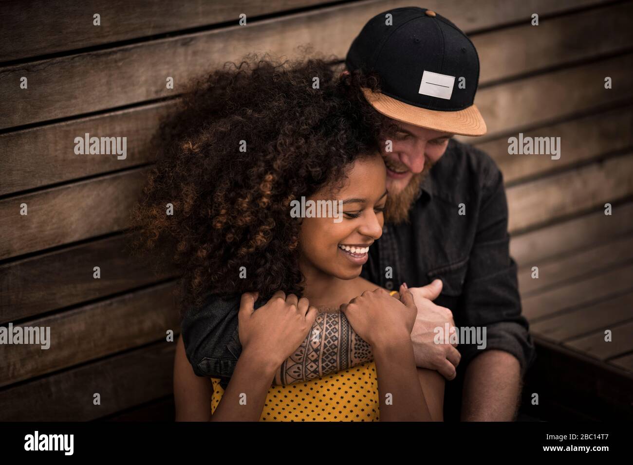 Joyful multicultural couple embracing hi-res stock photography and ...