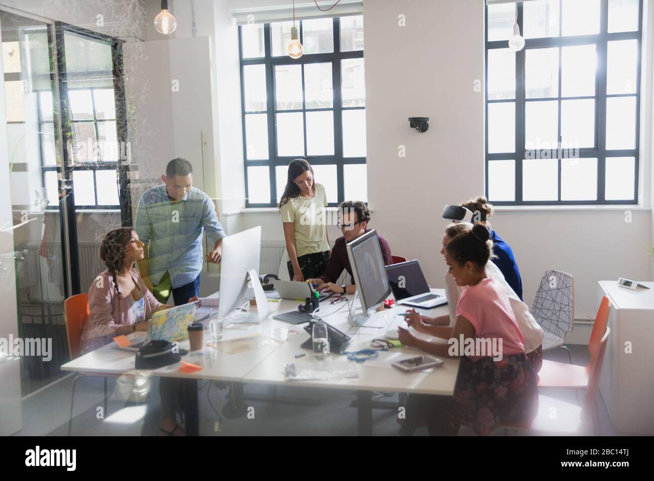 Designers working in open plan office Stock Photo - Alamy