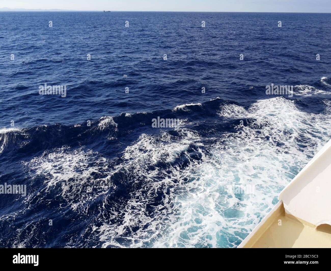 Foaming waves and ripples created by the propeller of a boat in the ...