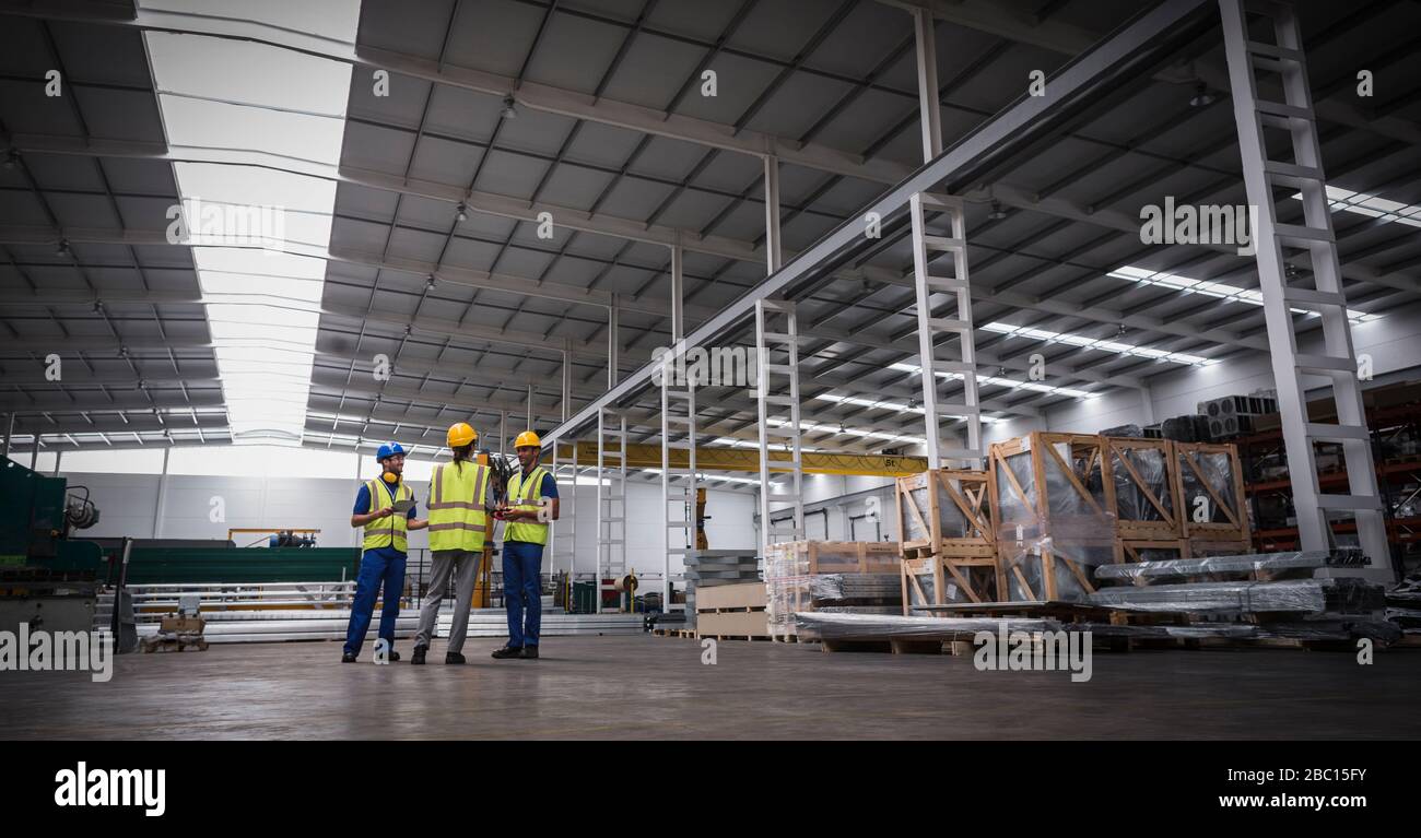 Workers talking in factory Stock Photo - Alamy
