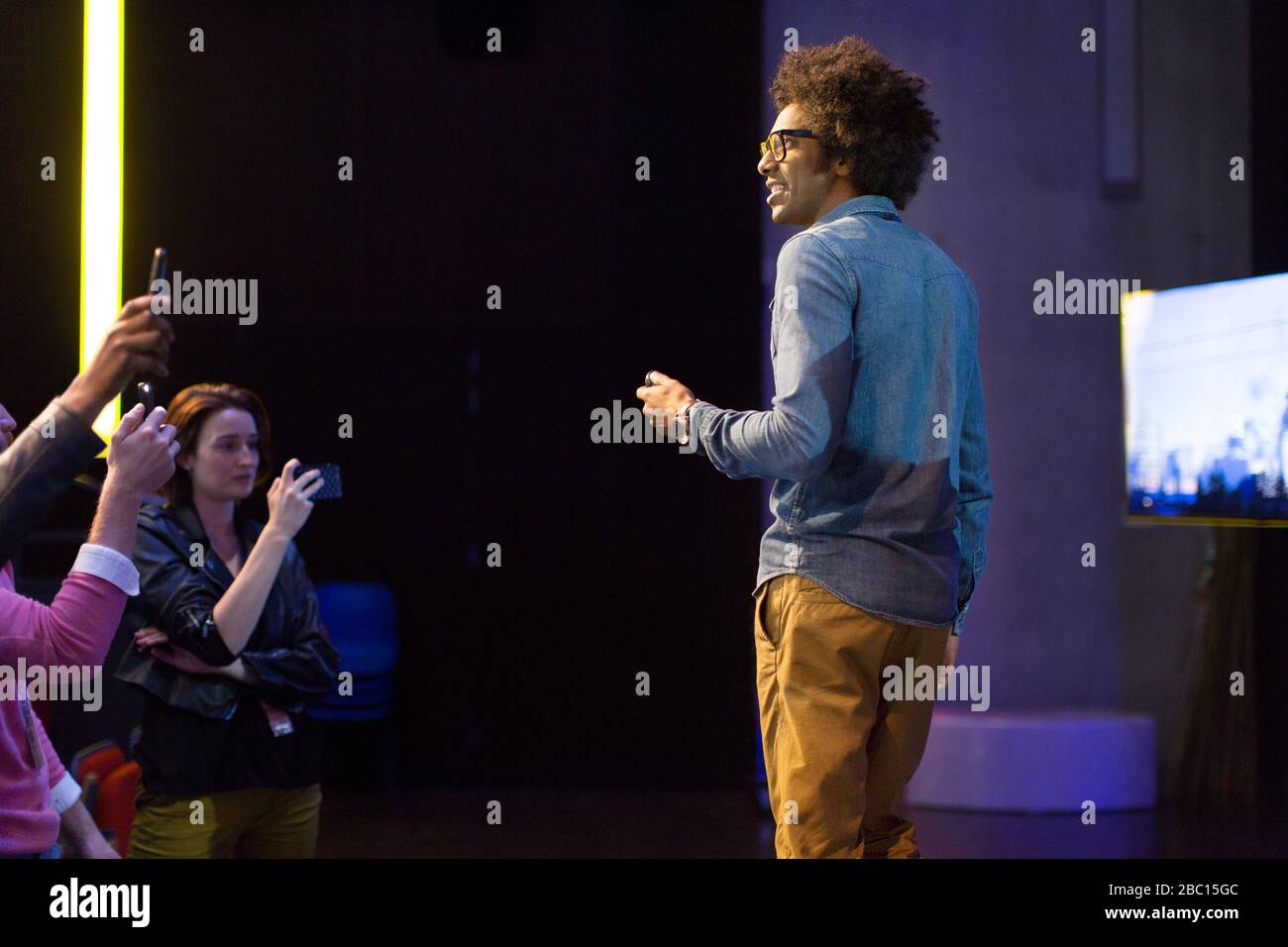 Male speaker talking on stage Stock Photo - Alamy