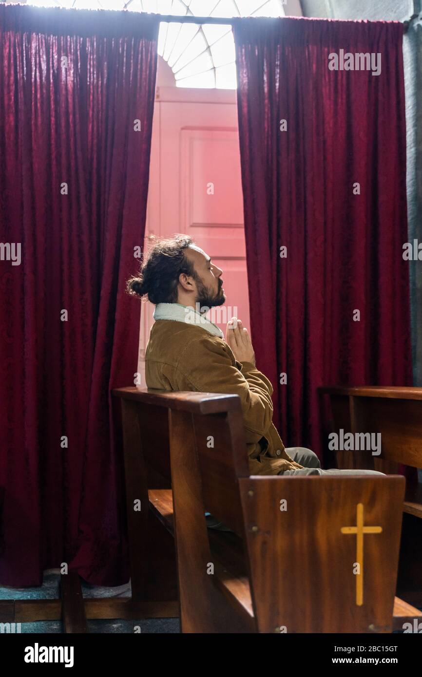 Man praying in a church Stock Photo - Alamy