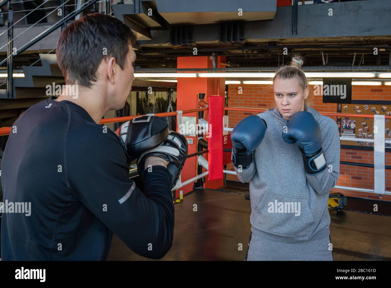 Female boxer sparring with her coach in gym Stock Photo - Alamy