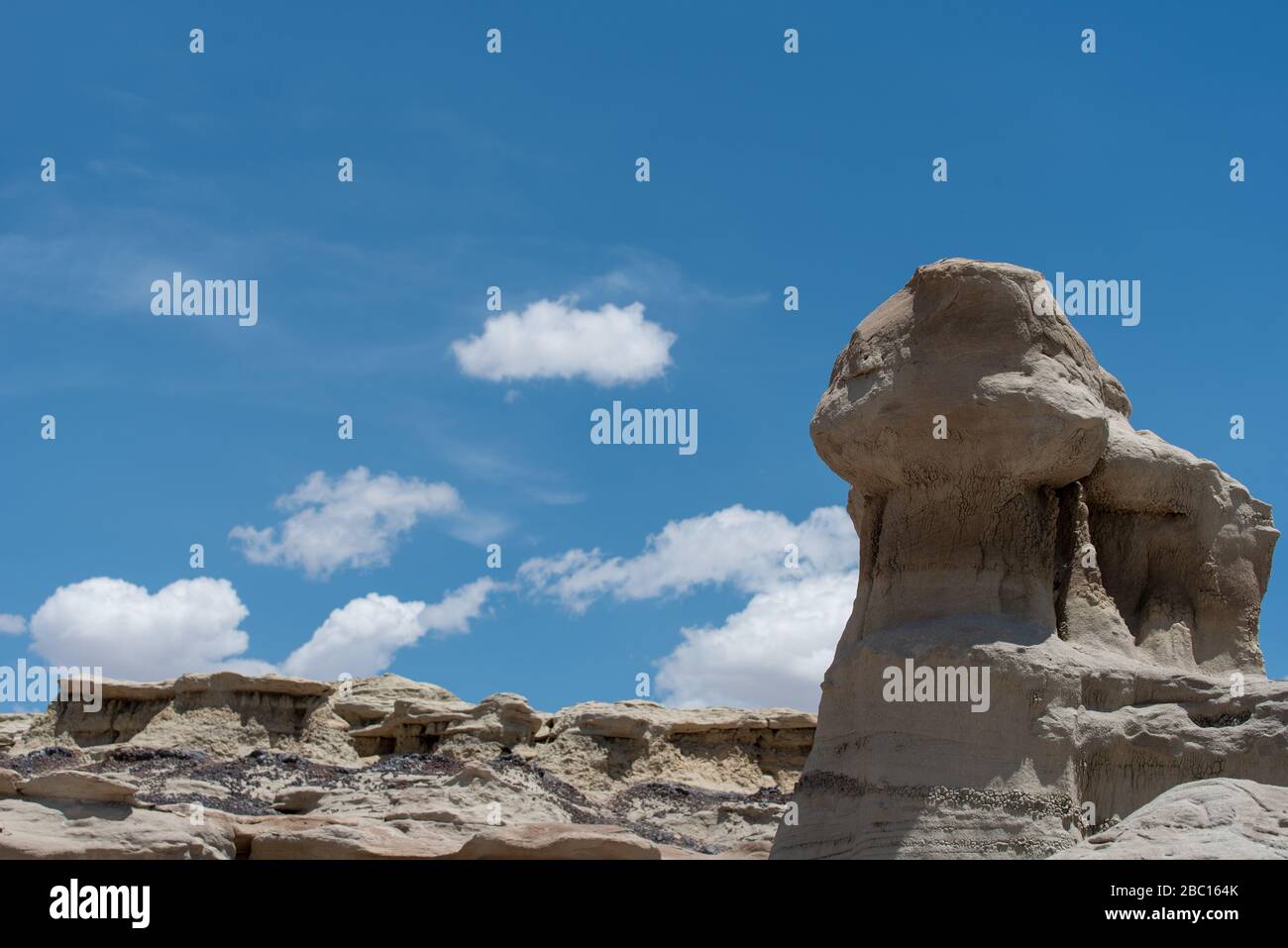 Landscape of a large grey rock formation against the sky at Bisti ...
