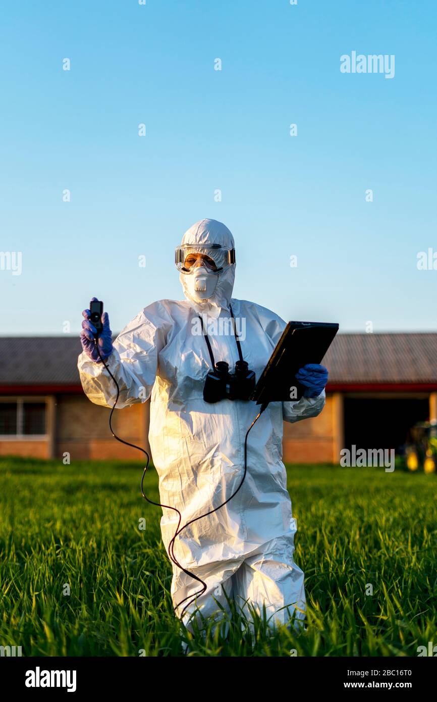 Female scientist researching in field and using measuring device Stock ...