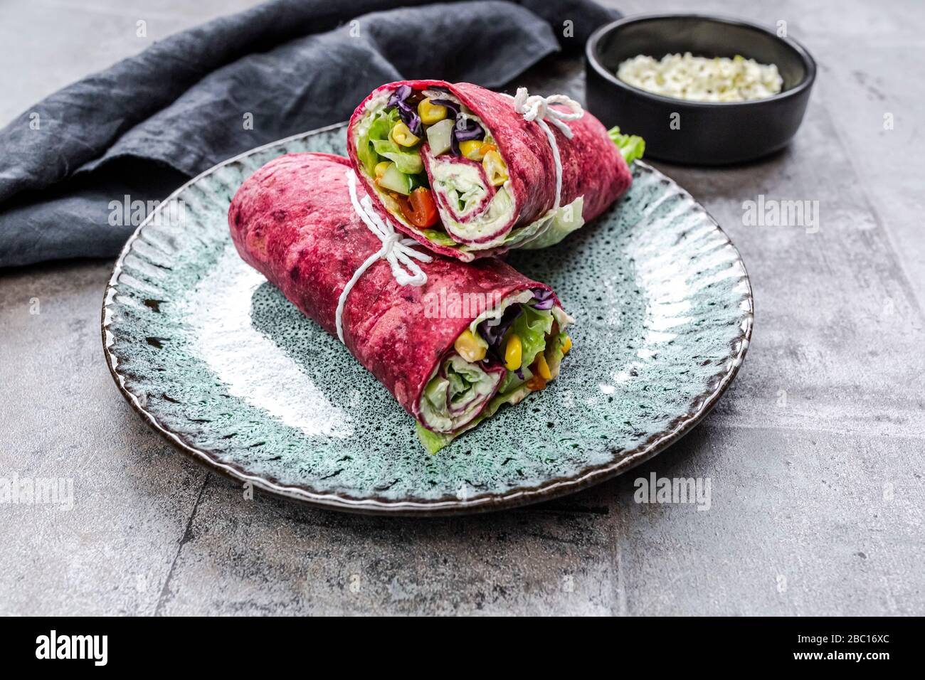 Vegetarian beetroot wraps filled with tomatoes, red cabbage, corn ...