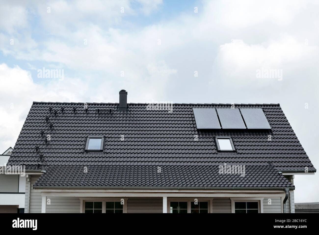 Rooftop of one-family house with three solar panels, Germany Stock ...