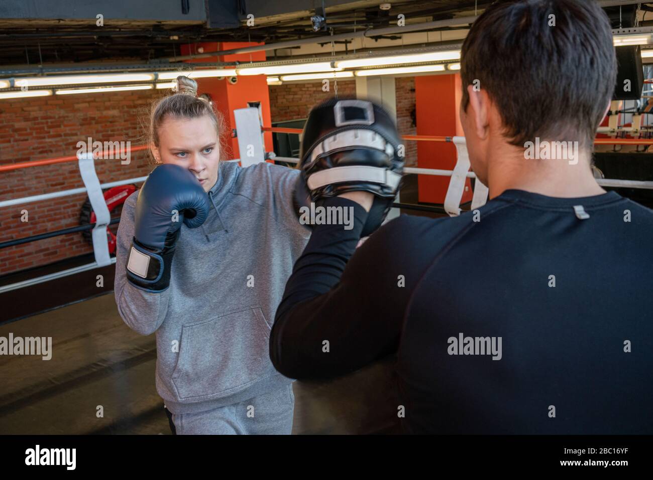 Female boxer sparring with her coach in gym Stock Photo - Alamy