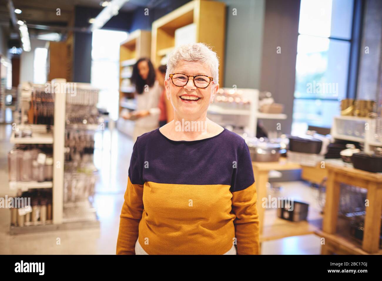 Portrait happy senior woman shopping in home goods store Stock Photo ...