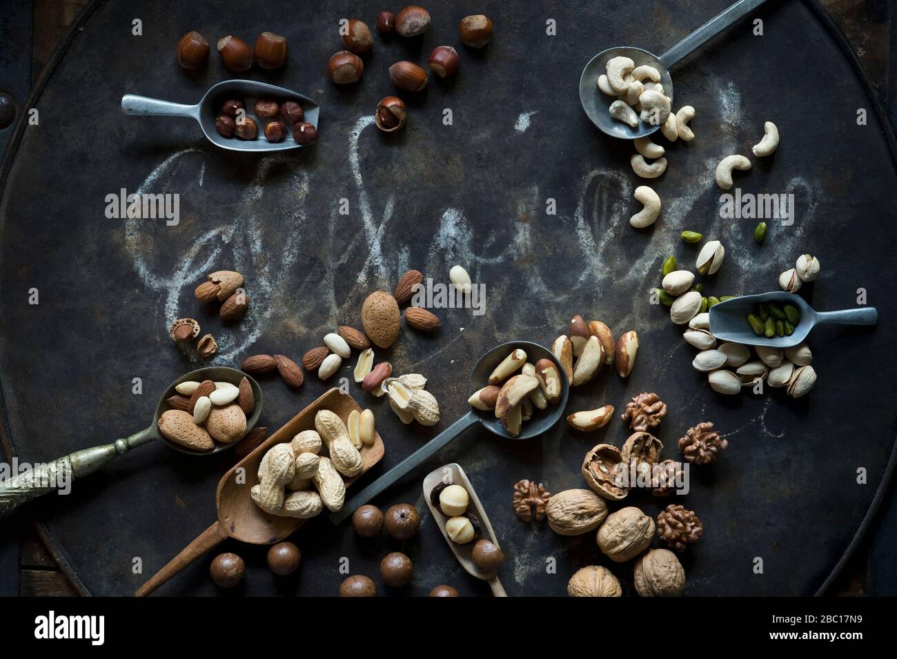 Scoops and spoons of various nuts Stock Photo - Alamy
