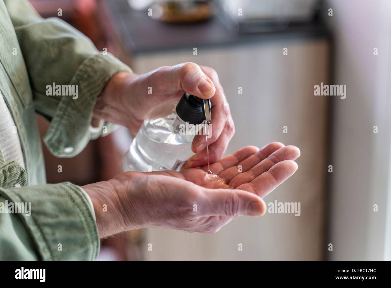 Hands of man, using hand sanitizer Stock Photo - Alamy