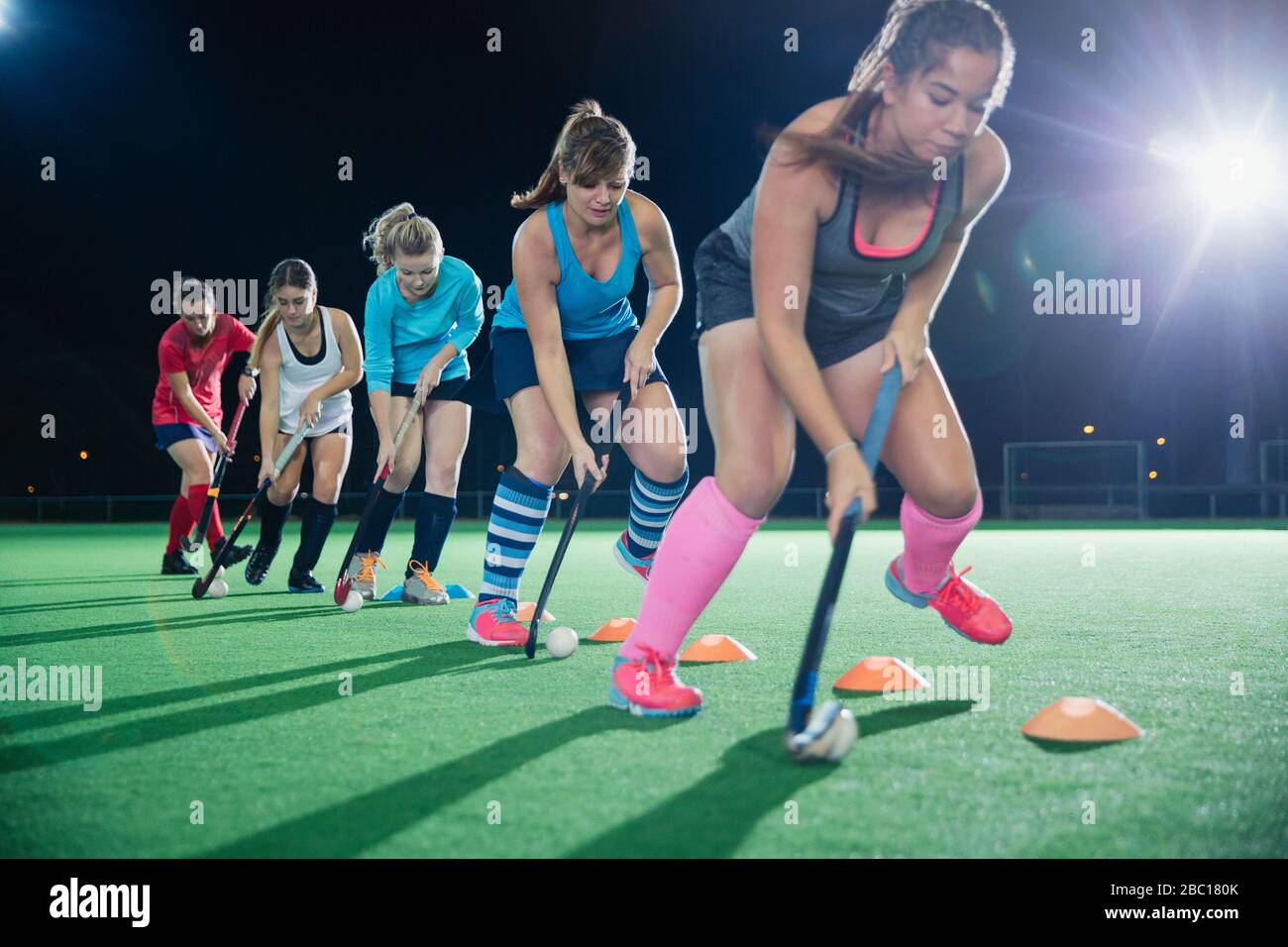 Female hockey player hitting ball hi-res stock photography and images ...