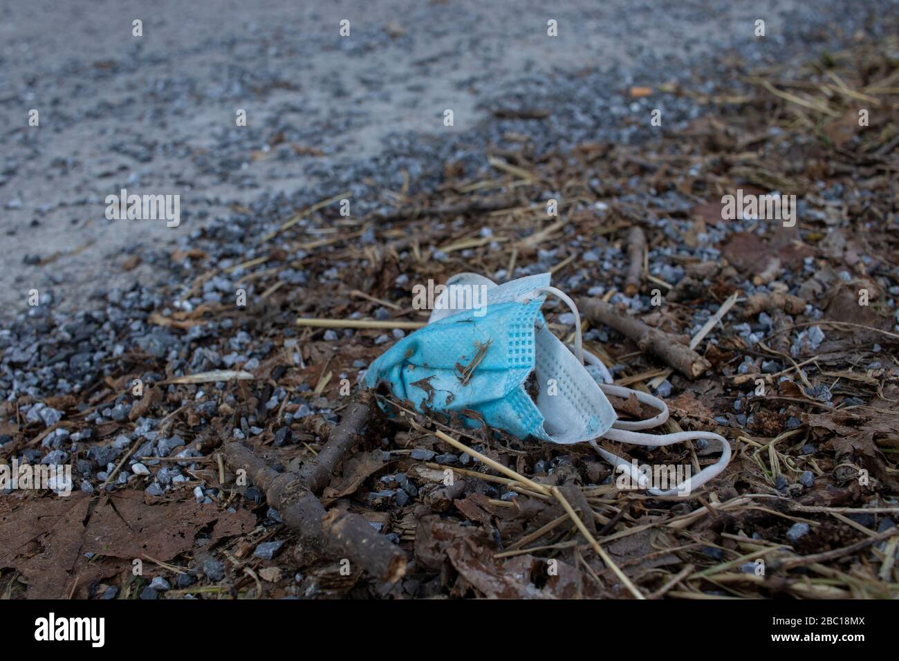 Low side view of medical surgical face mask outside on the ground ...