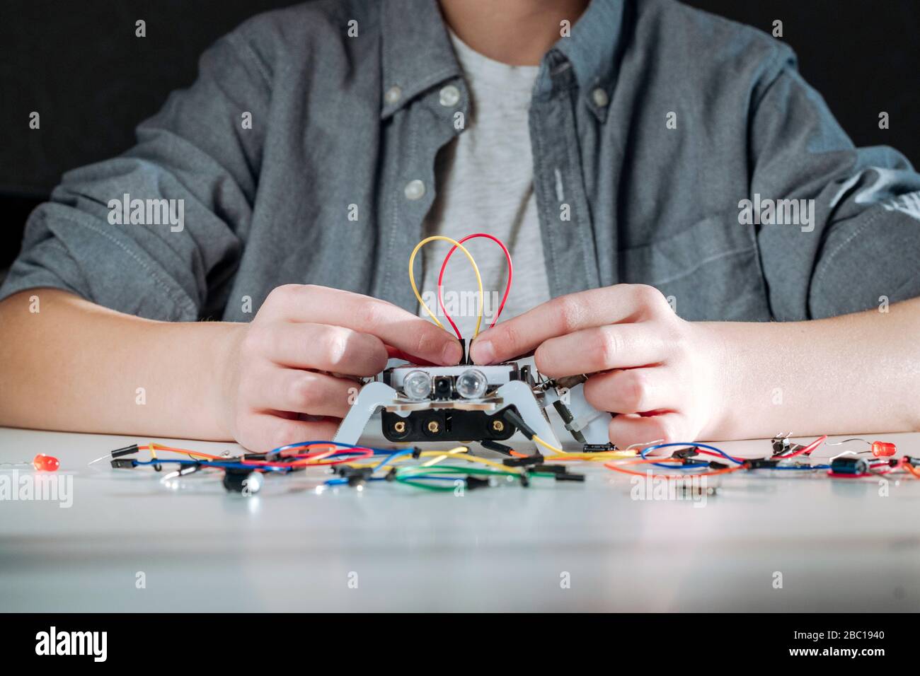 Boy assembling robot at home Stock Photo - Alamy